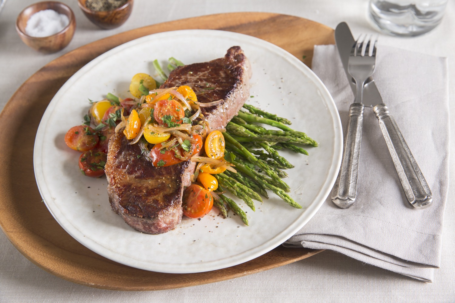 New York Strip Steaks with Shallots and Cherry Tomatoes